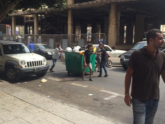 MTV Correspondent: Young men are hauling garbage cointainers onto the ...